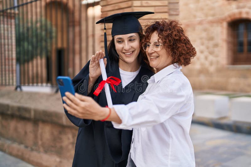 Two Women Mother And Daughter Holding Graduate Diploma Having Video