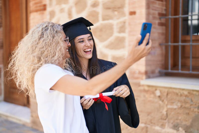 Two Women Mother And Graduated Daughter Make Selfie By Smartphone At