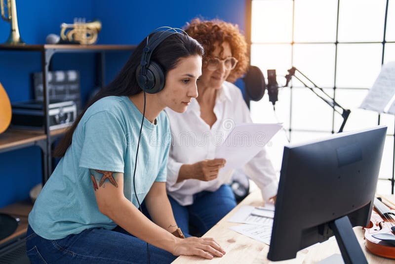 Two Women Musicians Composing Song Using Computer at Music Studio Stock ...