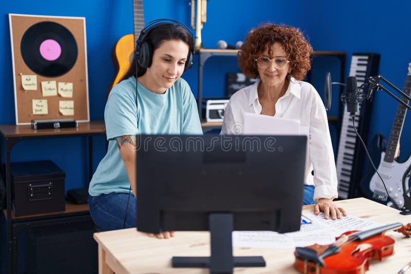 Two Women Musicians Composing Song Using Computer at Music Studio Stock ...