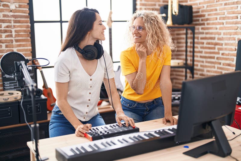 Two Women Musicians Composing Song Using Keyboard at Music Studio Stock ...