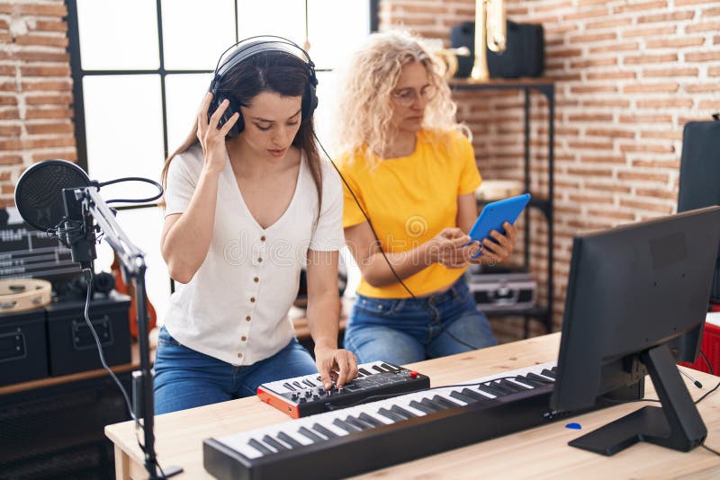 Two Women Musicians Composing Song Using Keyboard and Touchpad at Music ...