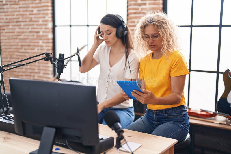 Two Women Musicians Composing Song Using Keyboard and Touchpad at Music ...