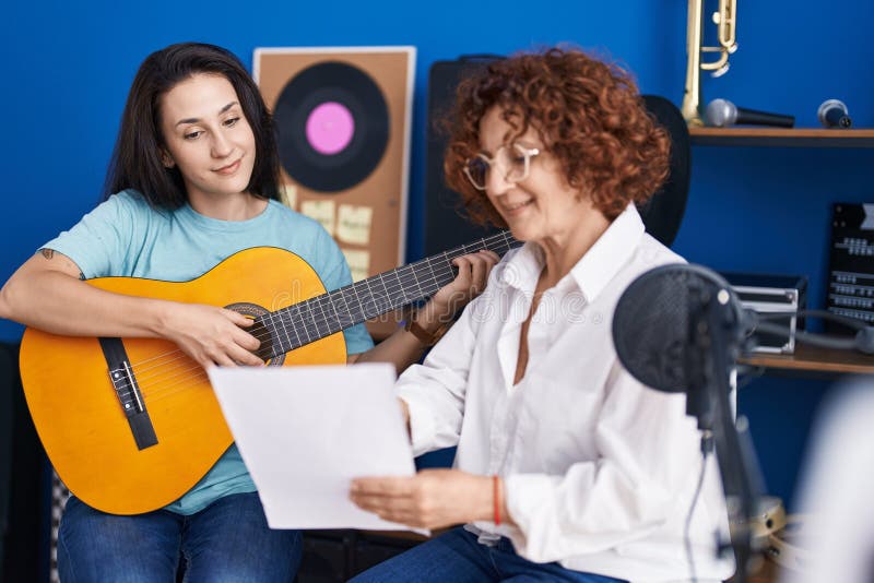 Two Women Musicians Having Classical Guitar Lesson at Music Studio ...