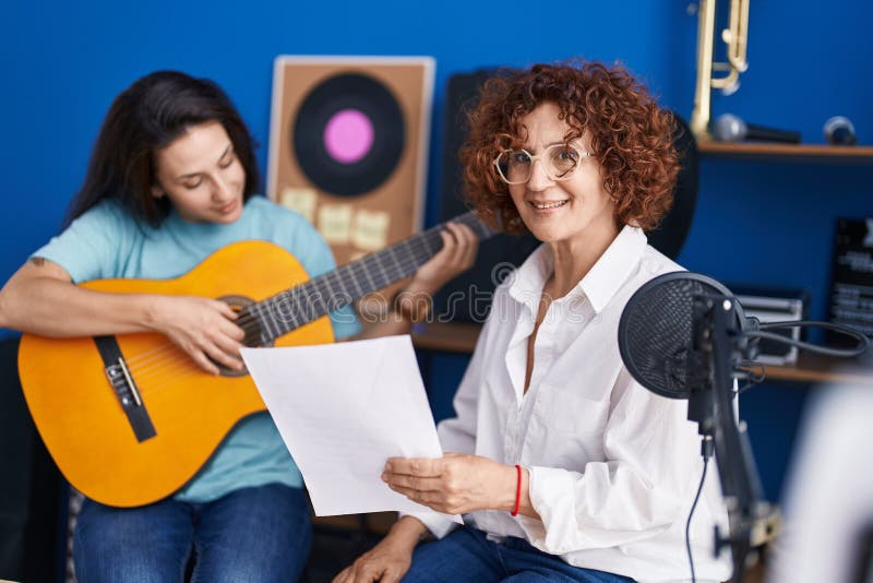 Two Women Musicians Having Classical Guitar Lesson at Music Studio ...