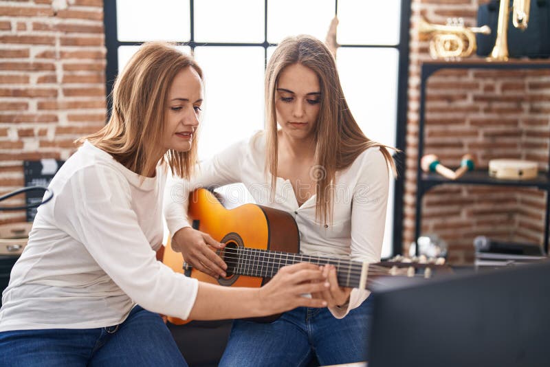 Two Women Musicians Having Classical Guitar Lesson at Music Studio ...
