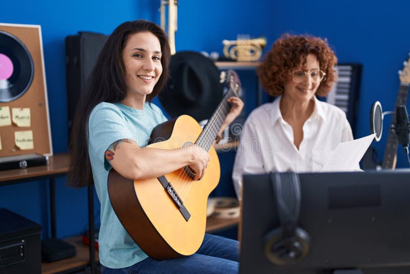Two Women Musicians Having Classical Guitar Lesson at Music Studio ...