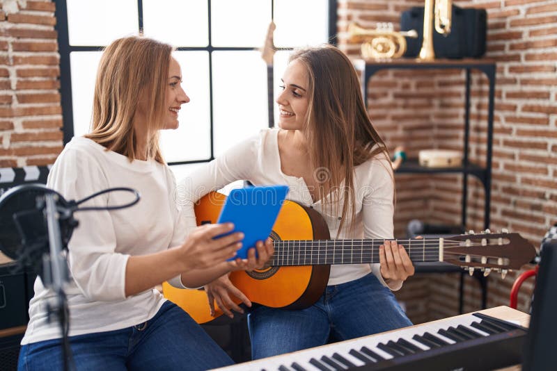 Two Women Musicians Having Classical Guitar Lesson at Music Studio ...