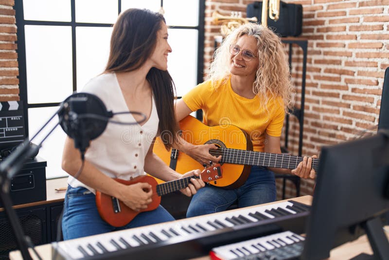 Two Women Musicians Playing Classical Guitar and Ukulele at Music ...