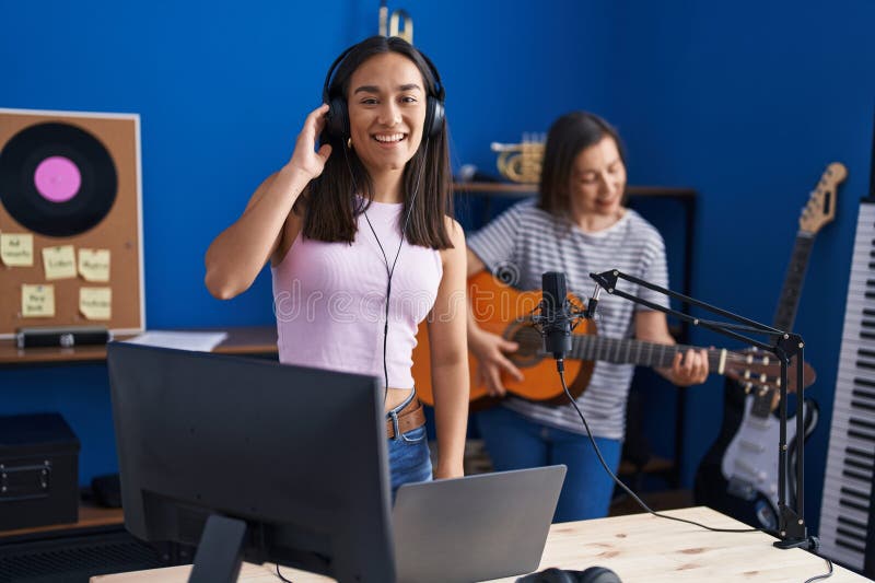 Two Women Musicians Playing Classical Guitar Using Laptp at Music ...