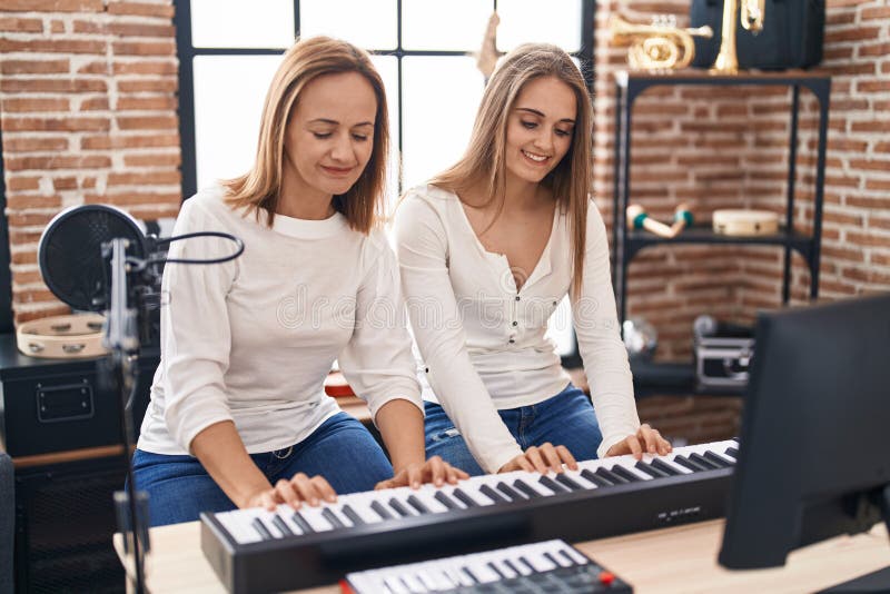 Two Women Musicians Playing Piano at Music Studio Stock Photo - Image ...
