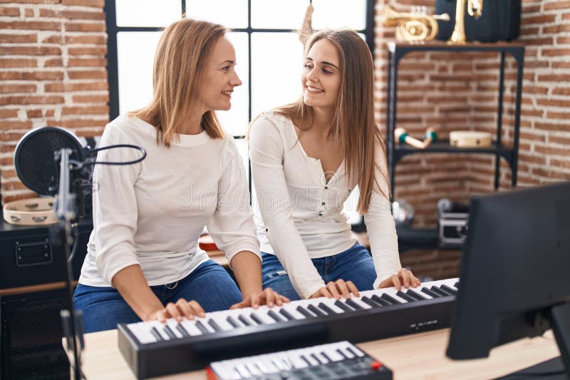 Two Women Musicians Playing Piano at Music Studio Stock Photo - Image ...