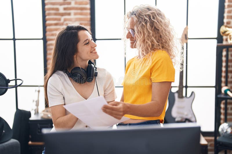 Two Women Musicians Reading Music Sheet at Music Studio Stock Photo ...