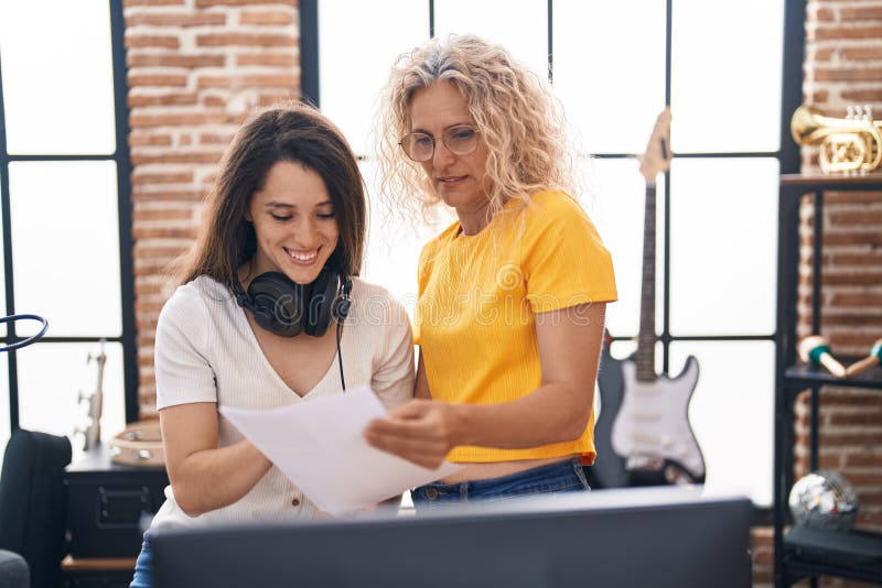 Two Women Musicians Reading Music Sheet at Music Studio Stock Photo ...