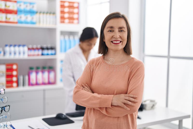 Two Women Pharmacist and Customer Smiling Confident at Pharmacy Stock ...