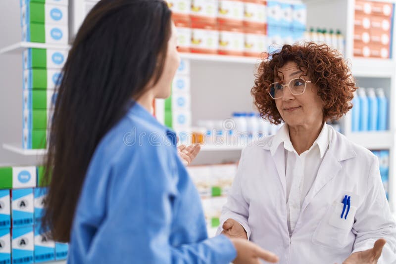 Two Women Pharmacist and Customer Speaking at Pharmacy Stock Image ...
