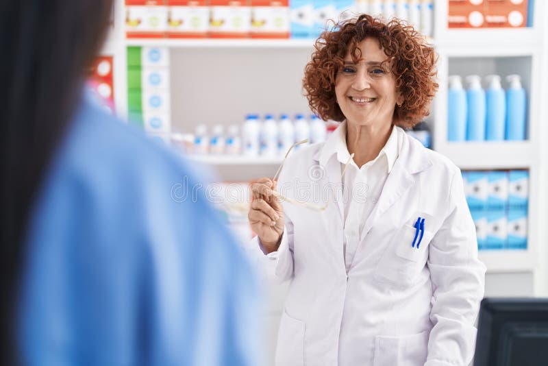 Two Women Pharmacist and Customer Speaking at Pharmacy Stock Image ...