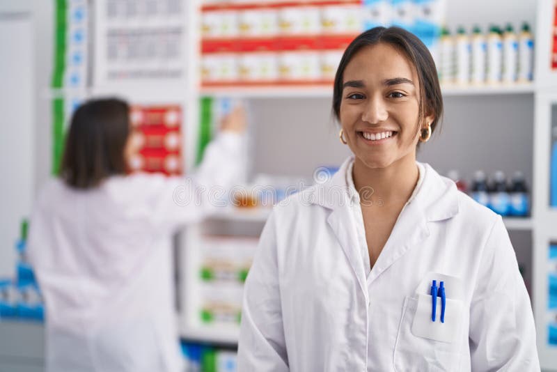 Two Women Pharmacist Smiling Confident Working at Pharmacy Stock Photo ...