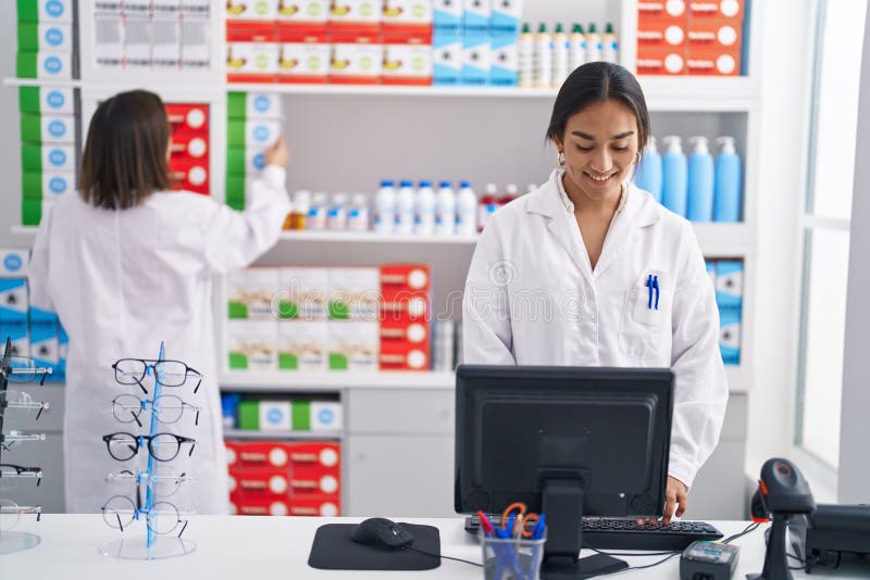 Two Women Pharmacist Using Computer Working at Pharmacy Stock Photo ...