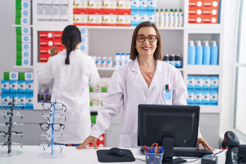 Two Women Pharmacist Using Computer Working at Pharmacy Stock Photo ...