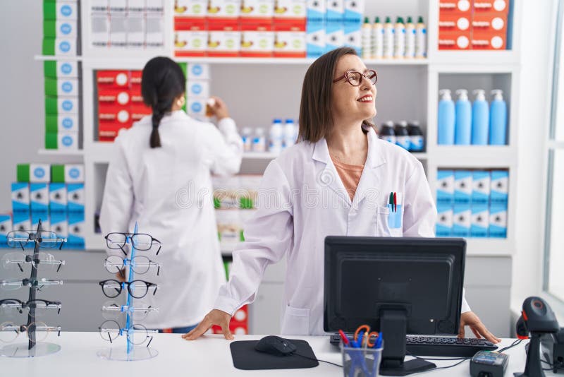 Two Women Pharmacist Using Computer Working at Pharmacy Stock Image ...