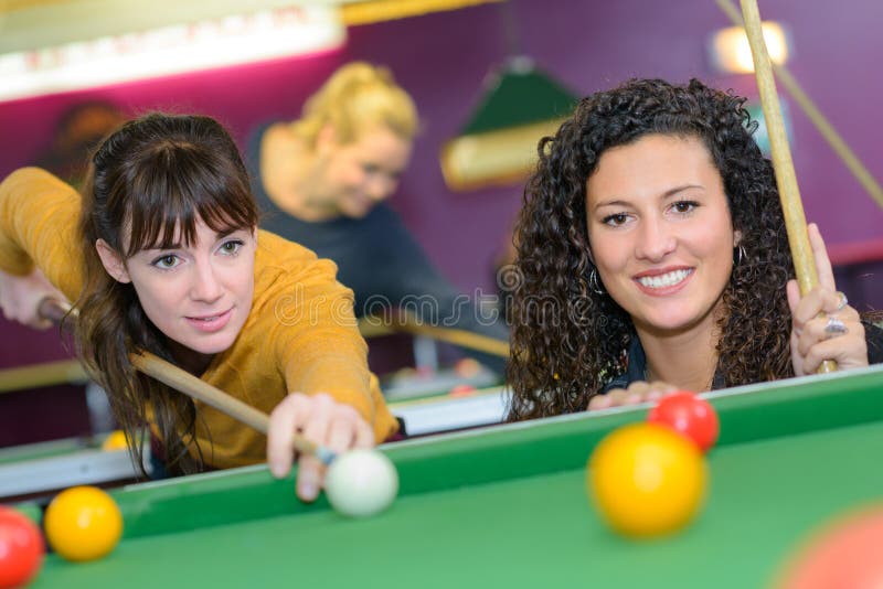 Two women playing pool stock photo. Image of table, casual - 118891704
