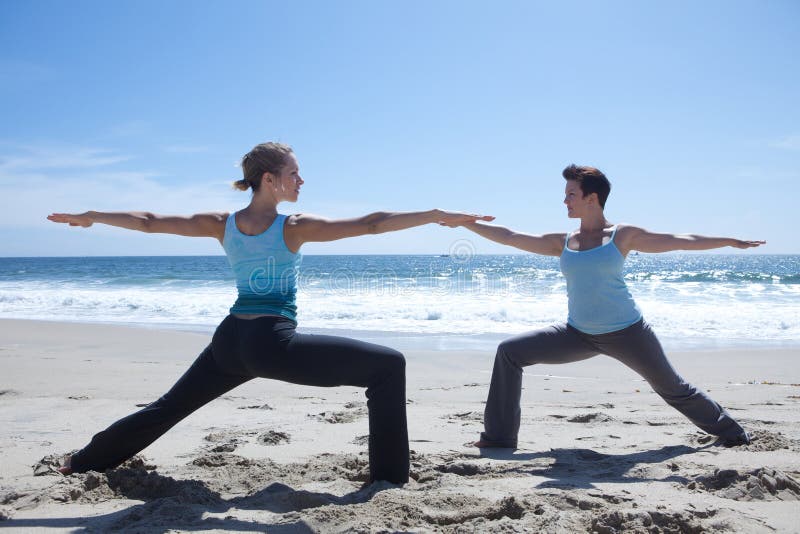 Two Women Practicing Yoga at the Beach Stock Image - Image of adult ...