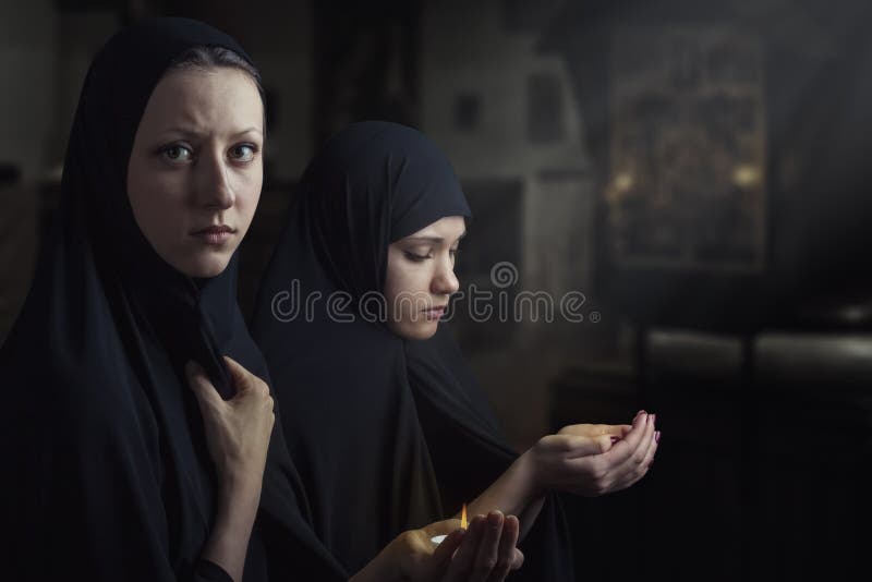 Two women pray stock image. Image of human, light, grace - 78922021
