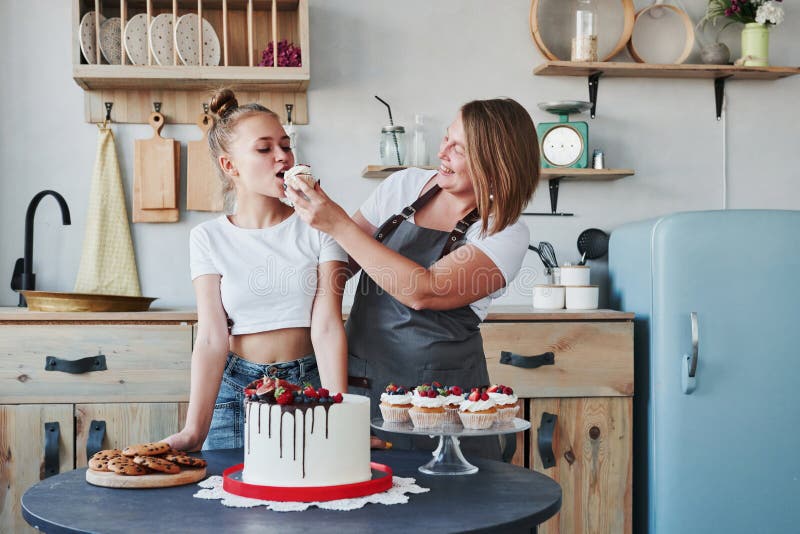 Two Women Preparing Delicious Sweets in the Kitchen Together Stock ...