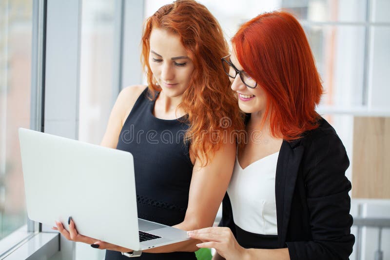 Two Women with Red Hair are Working in the Office Together Stock Image ...