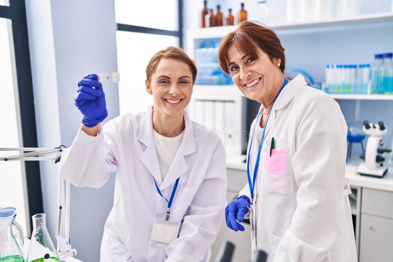 Two Women Scientist Smiling Confident Looking Sample at Laboratory ...