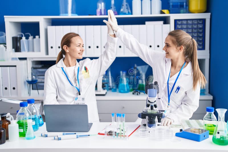 Two Women Scientists High Five with Hands Raised Up at Laboratory Stock ...