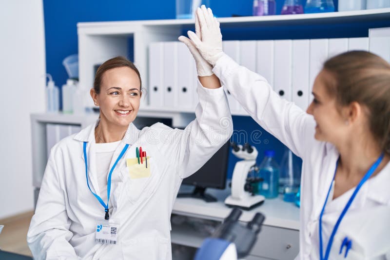 Two Women Scientists High Five with Hands Raised Up at Laboratory Stock ...