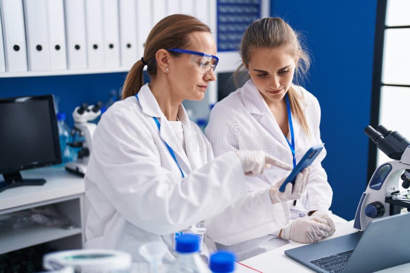 Two Women Scientists Using Smartphone Working at Laboratory Stock Photo ...