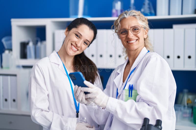 Two Women Scientists Using Smartphone Working at Laboratory Stock Photo ...