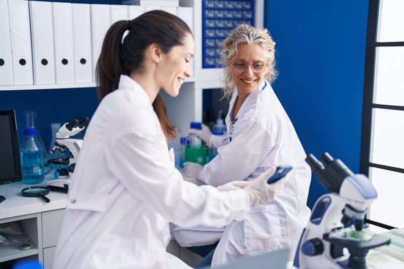Two Women Scientists Using Smartphone Working at Laboratory Stock Photo ...