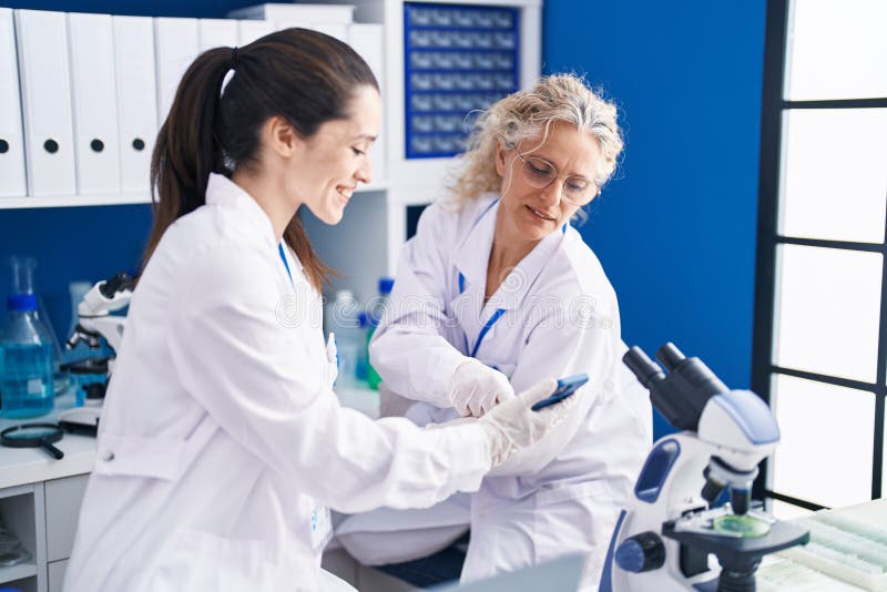 Two Women Scientists Using Smartphone Working at Laboratory Stock Photo ...