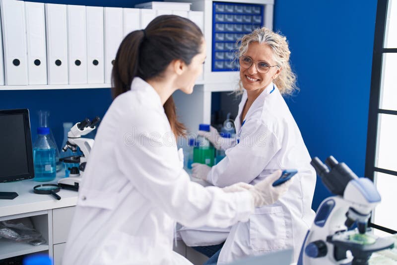 Two Women Scientists Using Smartphone Working at Laboratory Stock Photo ...