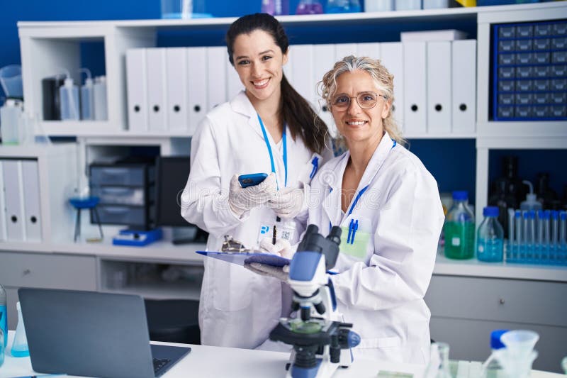Two Women Scientists Using Smartphone Working at Laboratory Stock Image ...