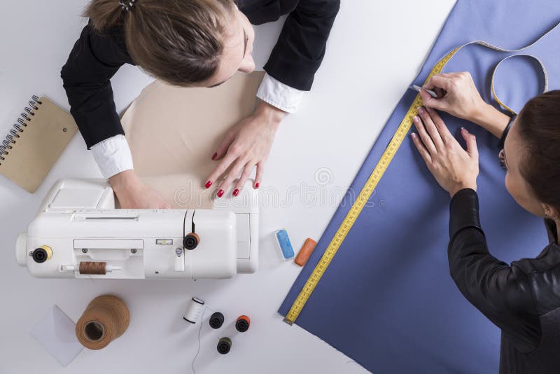 Two Women Sewing Together in a Tailor Shop Stock Image - Image of ...