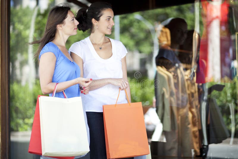 Two women shopping stock image. Image of looking, spend - 26240579