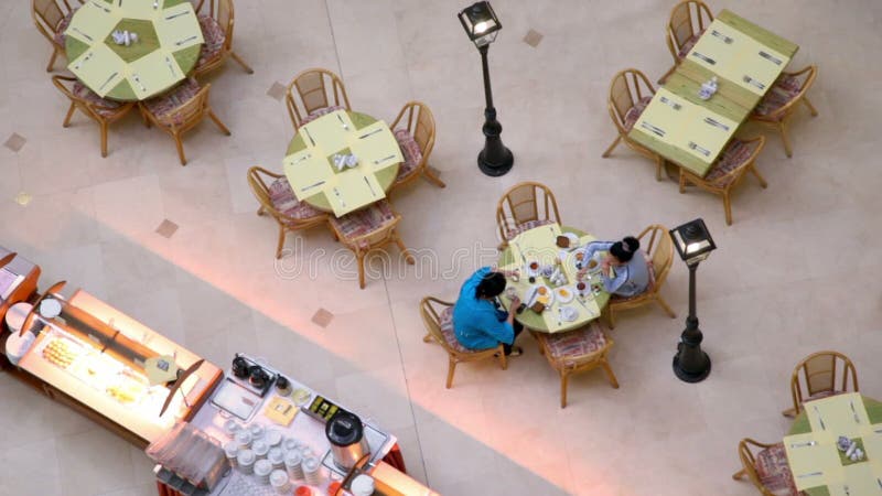 Two Women Sit at Table Near Buffet in Cafe, View Stock Video - Video of ...