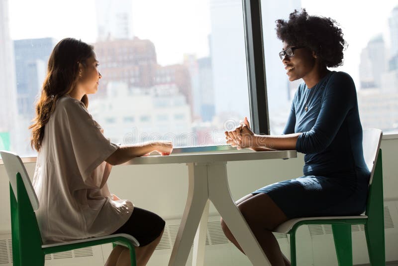 Two Women Sitting on Chairs beside Window Stock Photo - Image of people ...