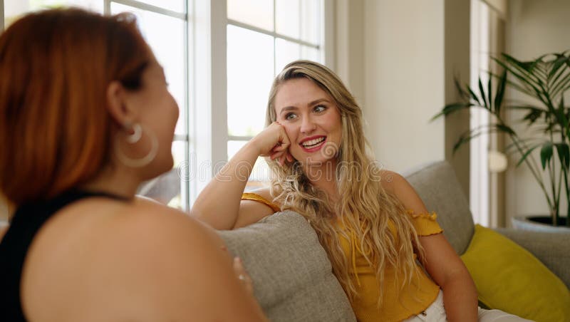 Two Women Sitting On Sofa Speaking At Home Stock Image Image Of
