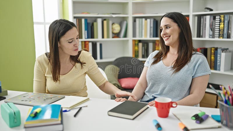 Two Women Sitting on Table Speaking at Library University Stock Image ...