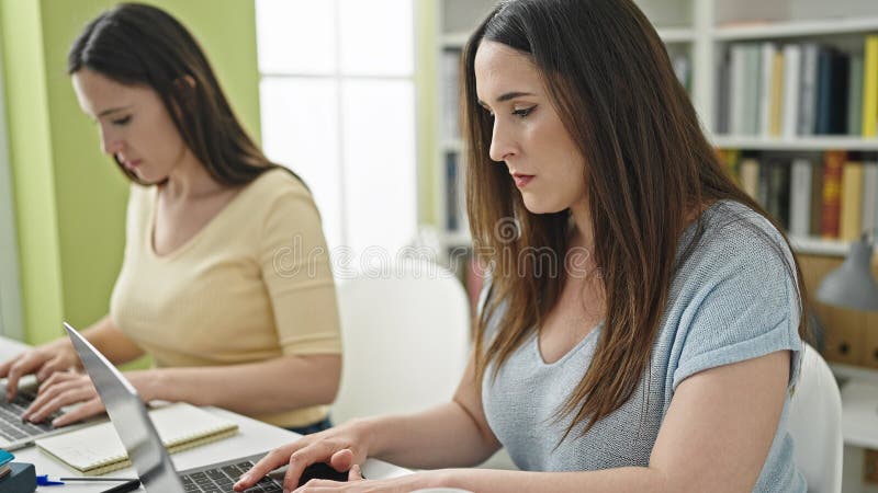 Two Women Sitting on Table Studying Using Laptop at Library University ...