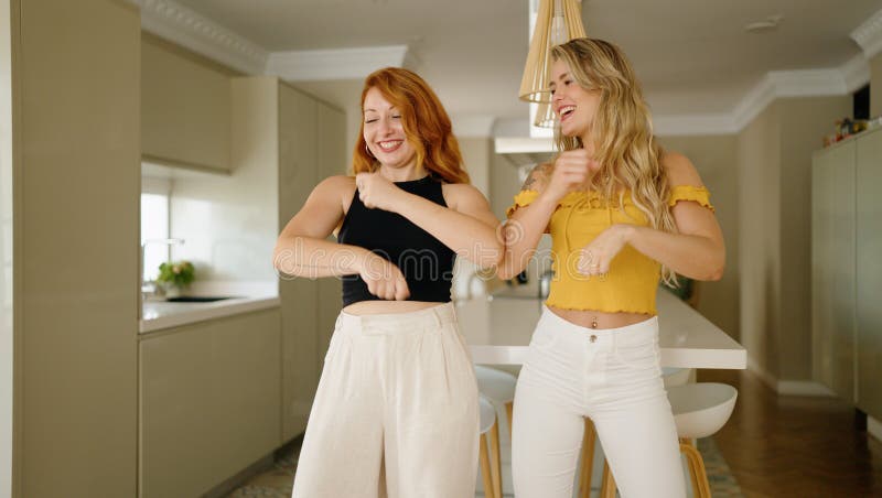 Two Women Smiling Confident Dancing Together at Kitchen Stock Image ...