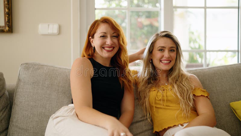 Two Women Smiling Confident Sitting On Sofa At Home Stock Image Image