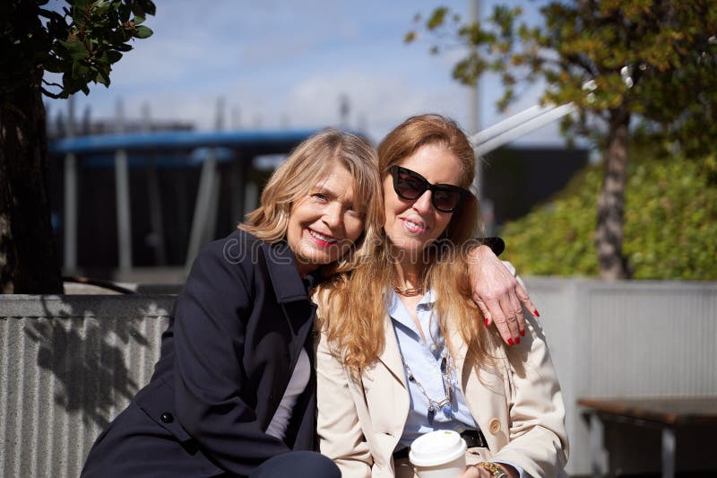 Two Women Smiling while Posing Together Outdoors. Stock Photo - Image ...