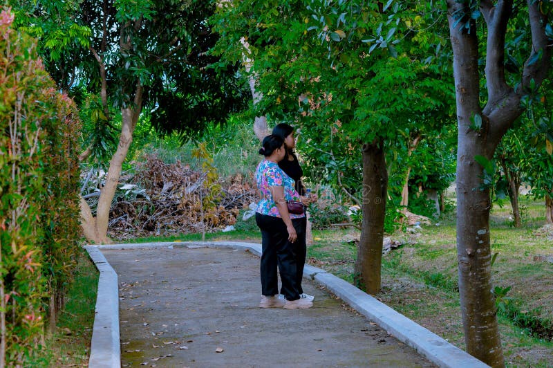 Two Women Standing Pathway Lush Garden Stock Photos - Free & Royalty ...